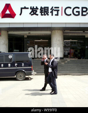 Two men walk past a branch of the Nationwide Building Society on The ...