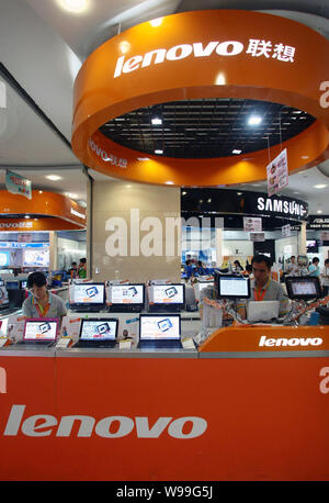 Chinese customers shop for Lenovo laptop computers at a shopping mall ...
