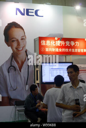 --File-- Visitors are seen at the stand of NEC during an exhibition in ...