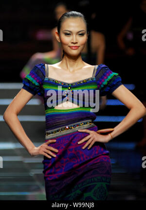 A model wearing garment with Chinese elements pose on the stage during ...