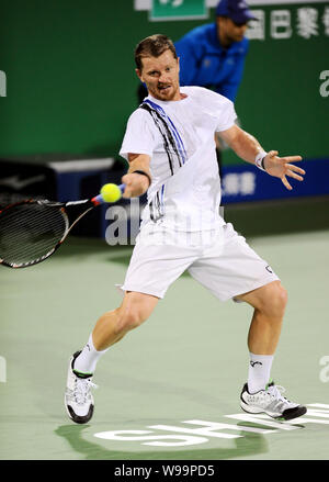 Alex Bogomolov of the United States returns a shot against Feliciano ...