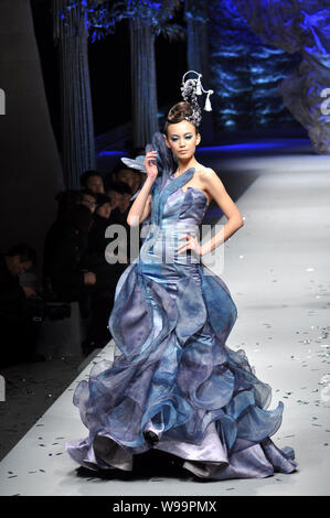 A model parades to show the new collection during the Botao 2012 Spring ...