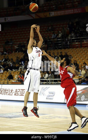 Kosuke Takeuchi of Japan plays a shot against South Korea during their ...