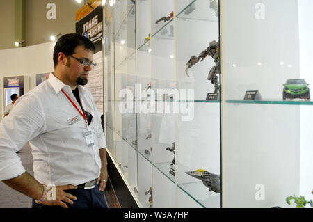 Designer Michelino Paolino of Hasbro Design poses in front of models of ...