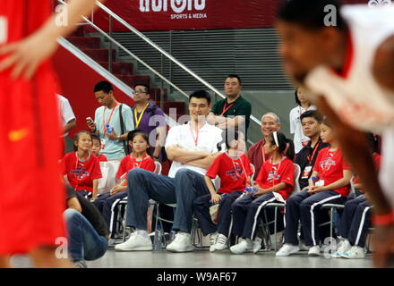 Yao Ming of the Houston Rockets watches from the bench during an NBA ...
