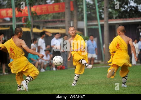 Young Chinese monks from Shaolin Temple Tagou Wushu School practise ...