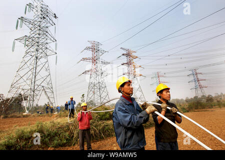 --FILE--High-voltage power lines on pylons transmit electricity from ...