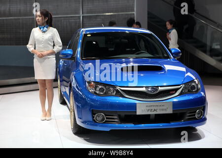 A model poses with a Subaru WRX STI on display during the 13th China ...