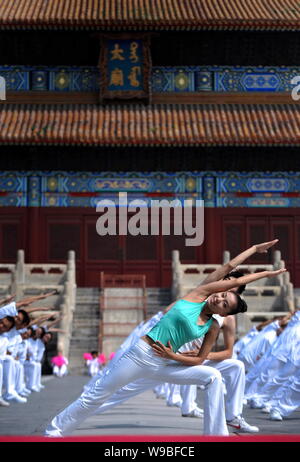 Chinese participants do a synchronized physical exercise during a ...
