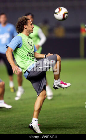 Uruguayan national soccer player Diego Forlan presents his trophy for ...