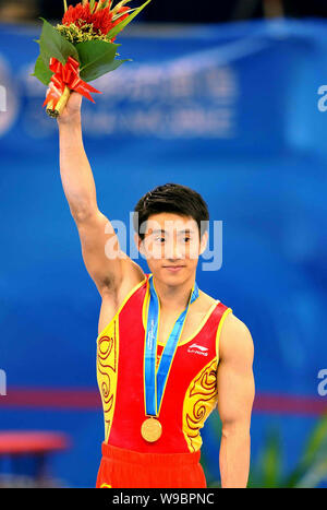 Men's individual all-around gold medalist, Ruoteng Xiao, centre, of ...