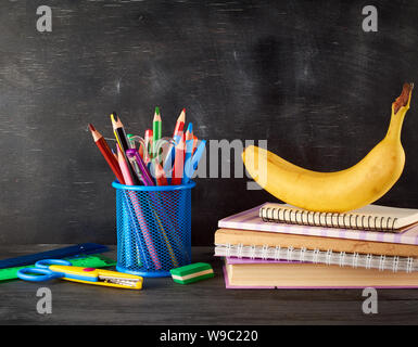 Notebooks, pencils and eraser on yellow background Stock Photo - Alamy