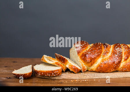 Sliced fresh challah bread on the wood table Stock Photo - Alamy