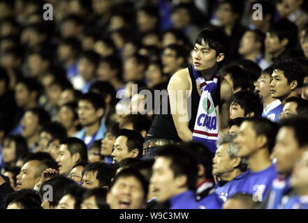 Fans watch a Champion league soccer match between Arsenal and Paris ...