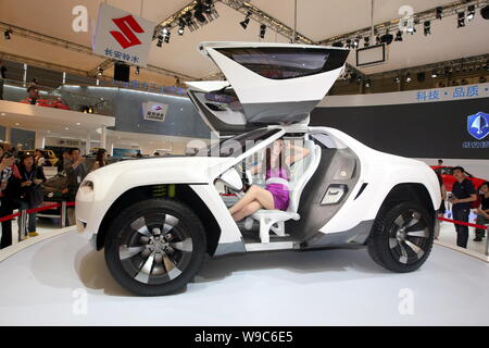 Visitors look at a Chana e301 Concept at the 13th Shanghai ...