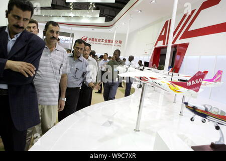 Visitors look at plane models at the stand of Aviation Industry ...