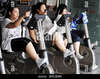 Chinese obese children exercise on steppers during a weight reduction ...