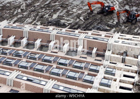 Excavators are seen dismantling the toppled apartment building at the ...
