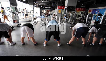 Chinese obese children exercise on steppers during a weight reduction ...
