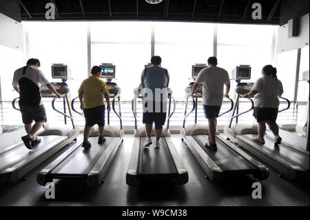 Chinese obese children exercise on steppers during a weight reduction ...