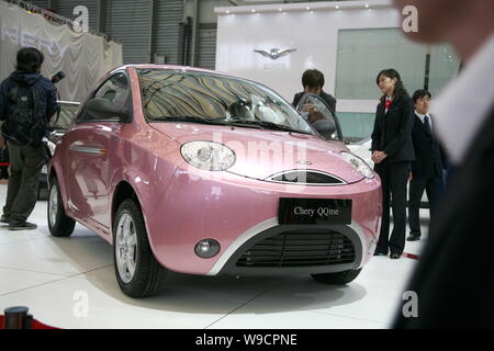 Visitors look at a Chery QQme at the 13th Shanghai International Automobile Industry Exhibition ...