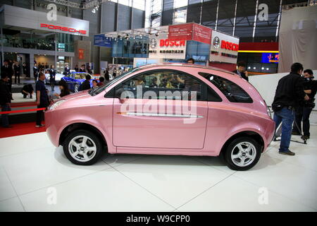 Visitors look at a Chery QQme at the 13th Shanghai International ...