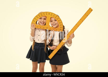Geometry lesson is much fun. Little girls holding protractor and ruler ...