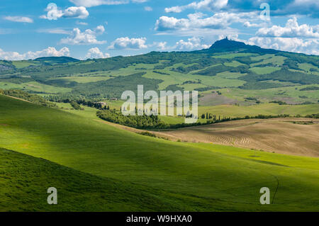 Beautiful view of Tuscany landscape hill at sunset, with mist and warm ...