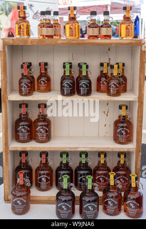 Maple syrup display. Jars, bottles, and cans of Canadian maple syrup on ...
