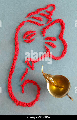 Ganesha symbol made of red powder color Stock Photo - Alamy