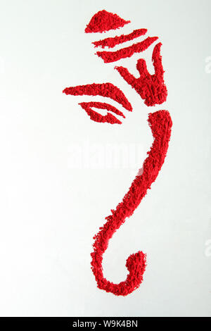 Ganesha symbol made of red powder color Stock Photo - Alamy
