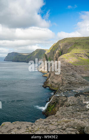 Bosdalafossur waterfall to the ocean on Faroe Islands coastline Stock ...