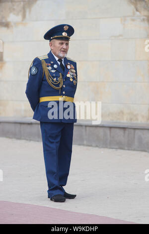 RUSSIA, KAZAN 09-08-2019: A wind instrument parade - a woman in green ...