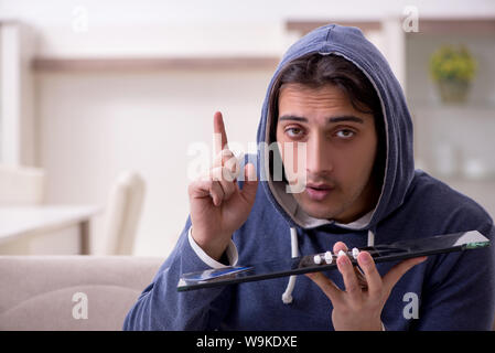 The young man having problems with narcotics at home Stock Photo - Alamy