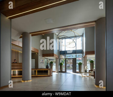 View through double-height entrance foyer with reception and ...