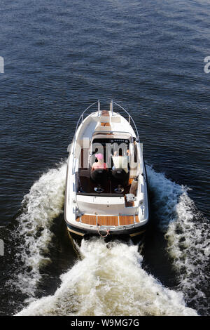 High angle view of a motor boat sailing on a vast blue sea near Koper ...