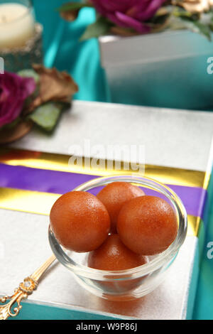Gift boxes with a bowl of gulab jamun Stock Photo - Alamy