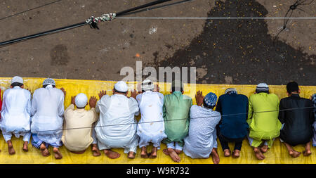 Muslim men and children bowing down and offering Namaz prayers on the ...