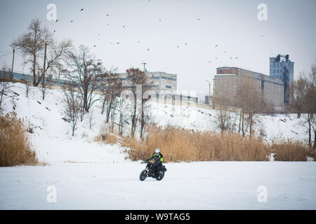A guy rides a motorcycle on a frozen lake Stock Photo - Alamy
