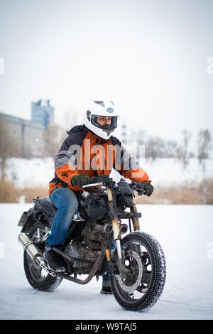A guy rides a motorcycle on a frozen lake Stock Photo - Alamy