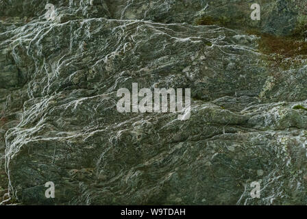 background, texture - bizarrely wrinkled surface of natural old rock ...