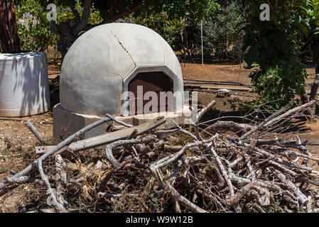 Traditional Greek and Cyprus kleftiko oven with burning fire inside ...