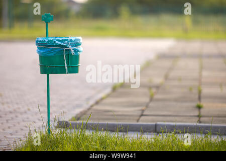 Garbage bin outdoor on blurred sunny background Stock Photo - Alamy