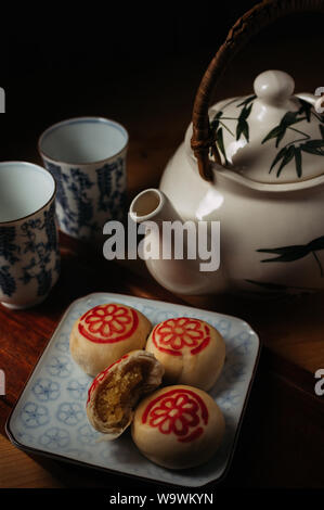 Clay jug on a dark background on a wooden table Stock Photo - Alamy