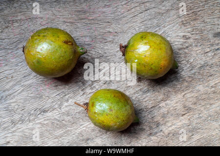 Close-up of exotic fruit Grugru nuts "Macauba" on wooden background ...