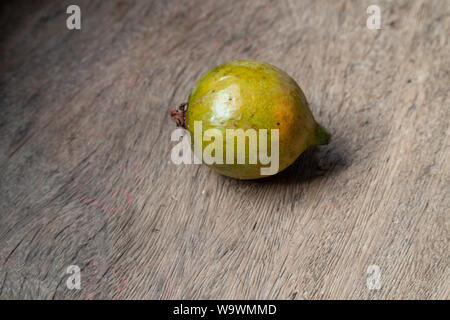 Close-up of exotic fruit Grugru nuts "Macauba" on wooden background ...