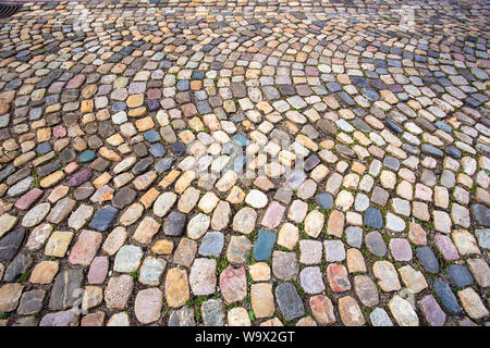 Old mosaic colorful granite cobblestone pavement. Abstract background ...
