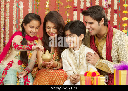 Family celebrating Diwali and collecting money Stock Photo - Alamy