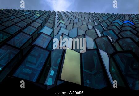 High rise architectural brutalism style apartment building behind metal ...