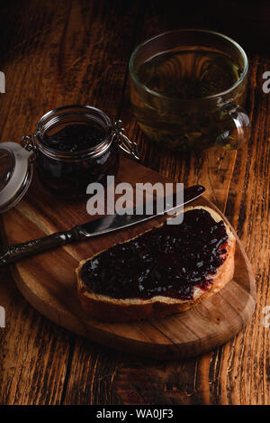 Delicious toast with jam and cup of tea on table close-up Stock Photo ...